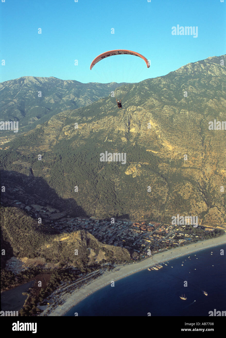 paraglider flying over beach at oludeniz Stock Photo - Alamy
