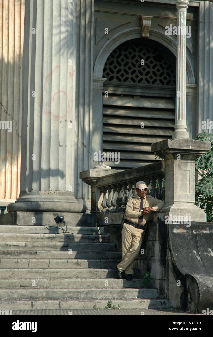 Guard protecting church entrance in front of the Old Cathedral, Managua ...