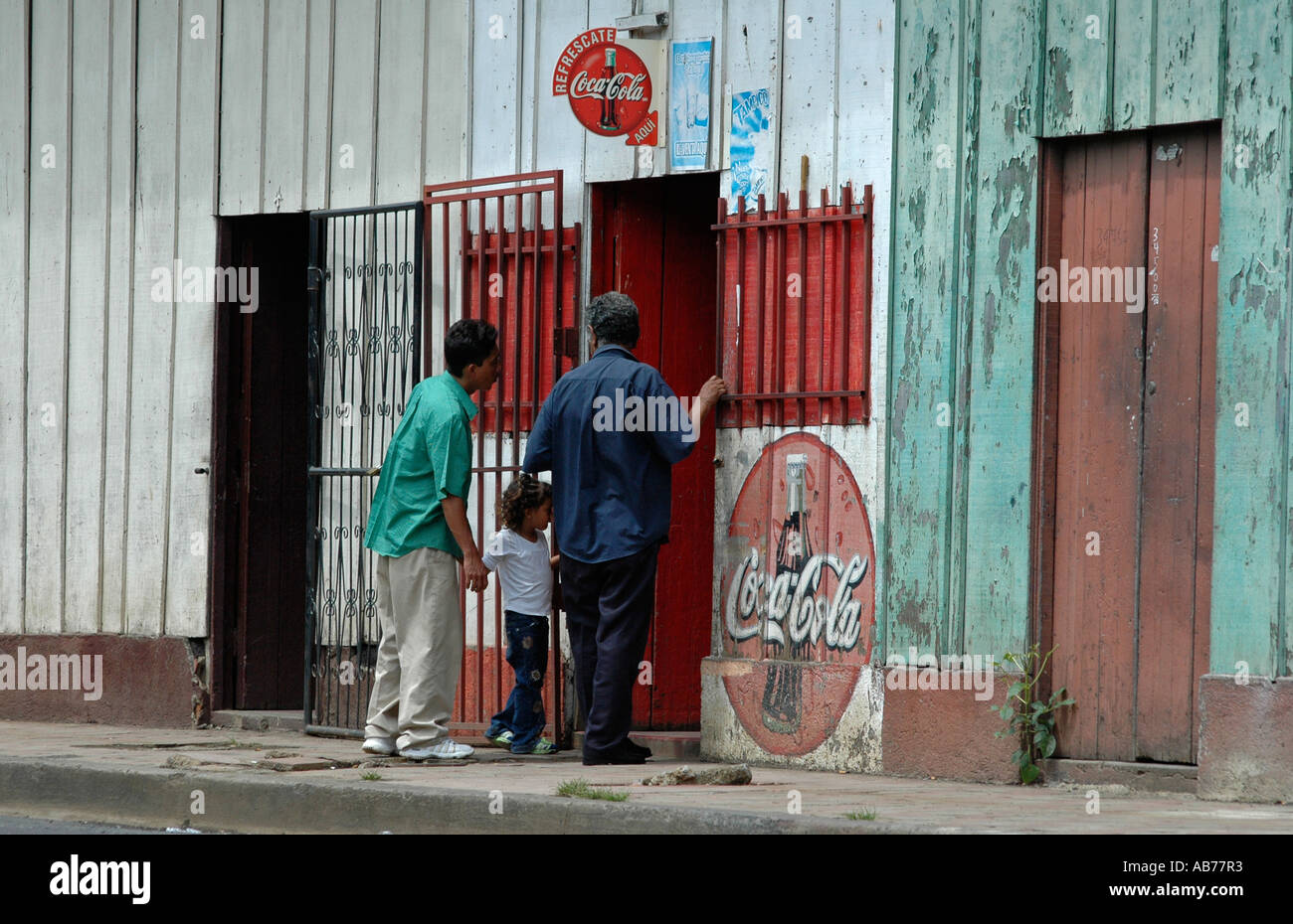 People buying from a local store in a poor district of Managua, capital ...