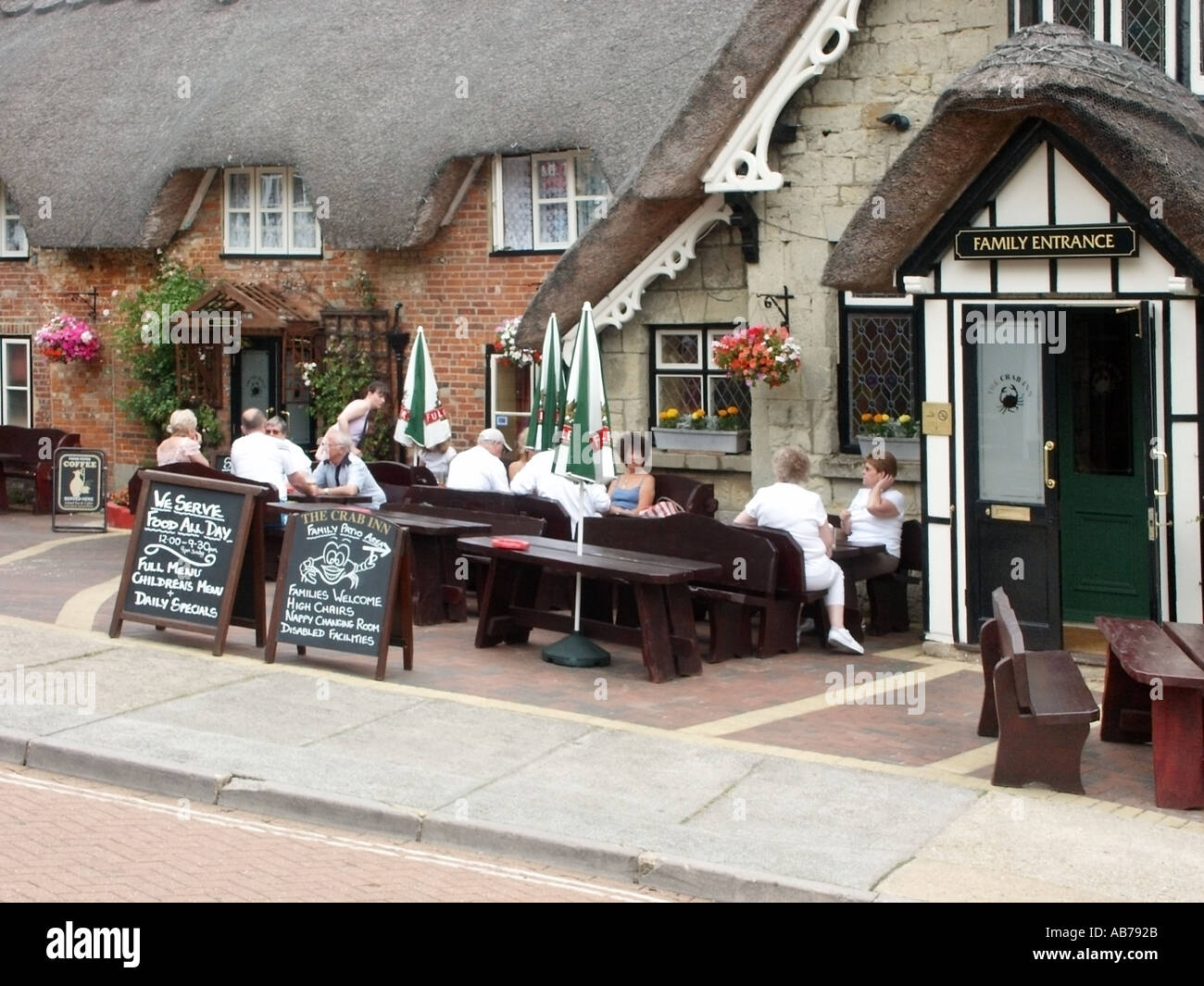 Shanklin people relaxing outside The Crab Inn Stock Photo - Alamy