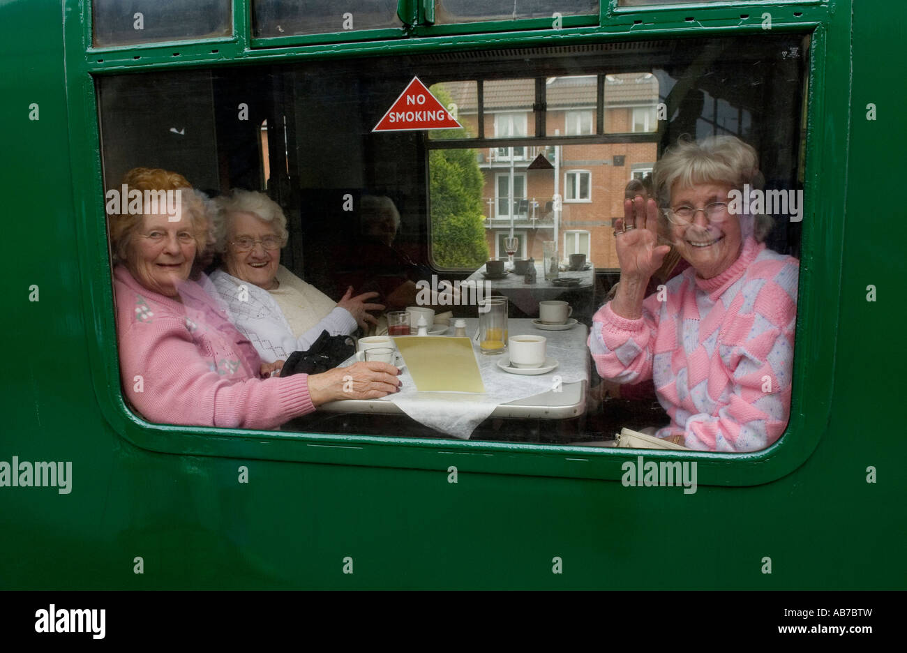 ELDERLY LADIES TAKE AFTERNOON TEA ON A TRAIN ON THE WATERCRESS LINE ...