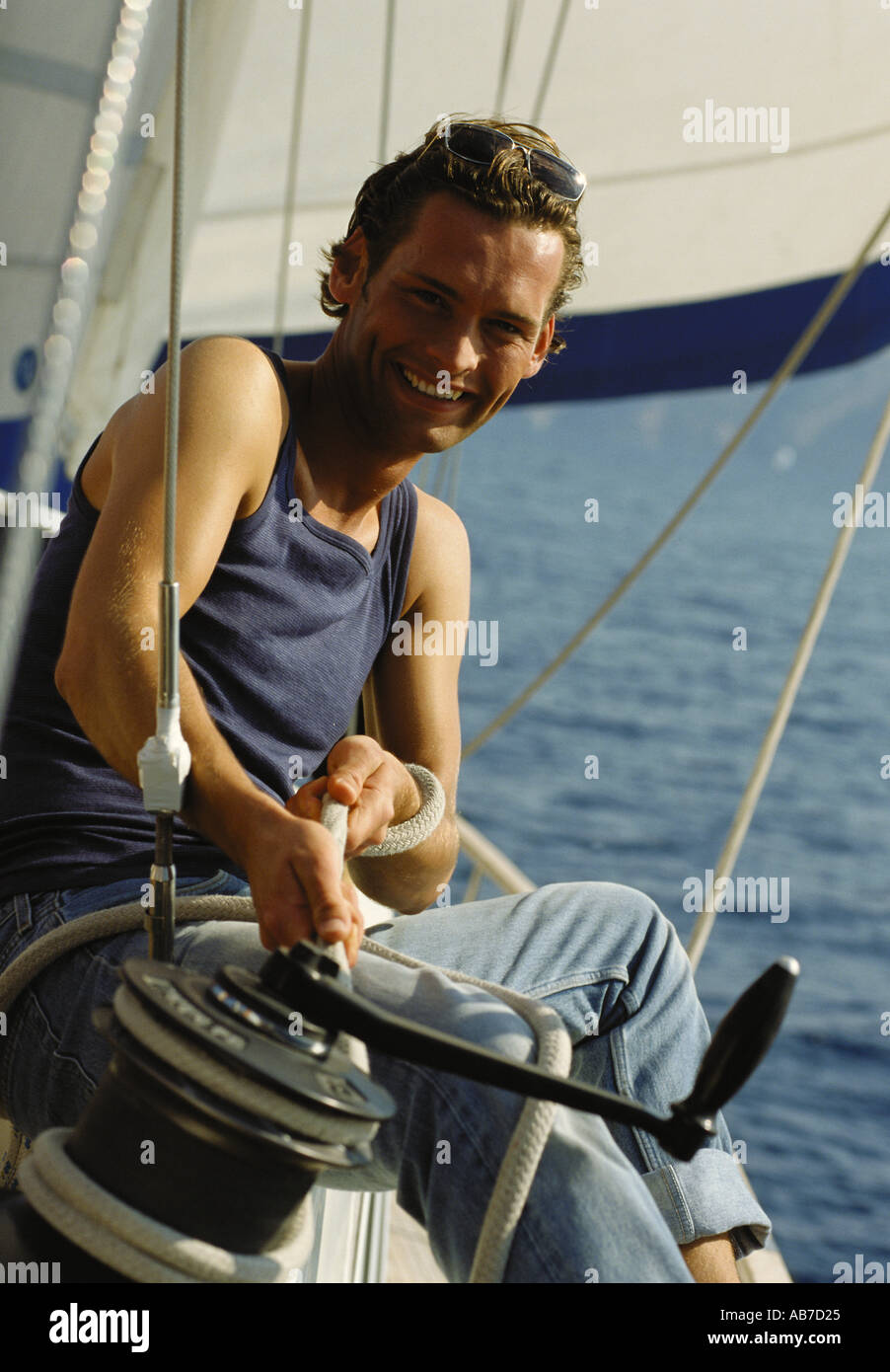 Man on sailing boat Stock Photo - Alamy