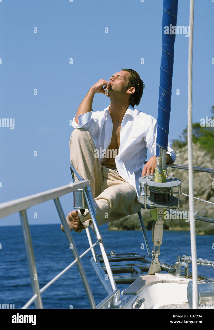 Man on sailing boat Stock Photo - Alamy