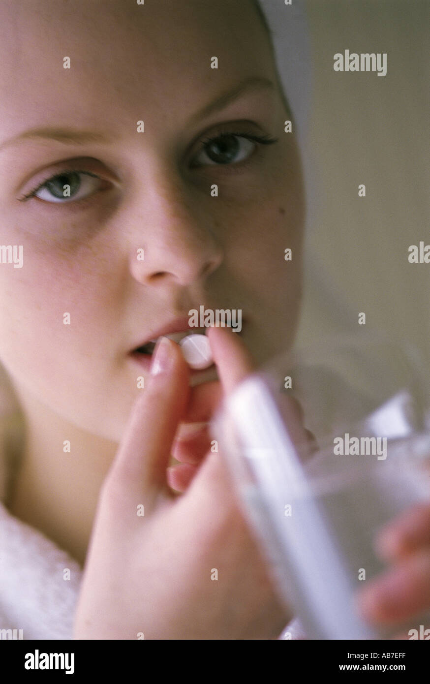 Girl taking tablet Stock Photo - Alamy