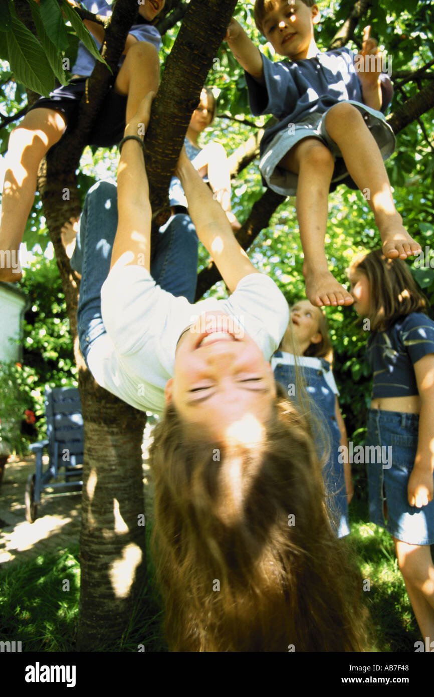 Kids playing in tree Stock Photo - Alamy