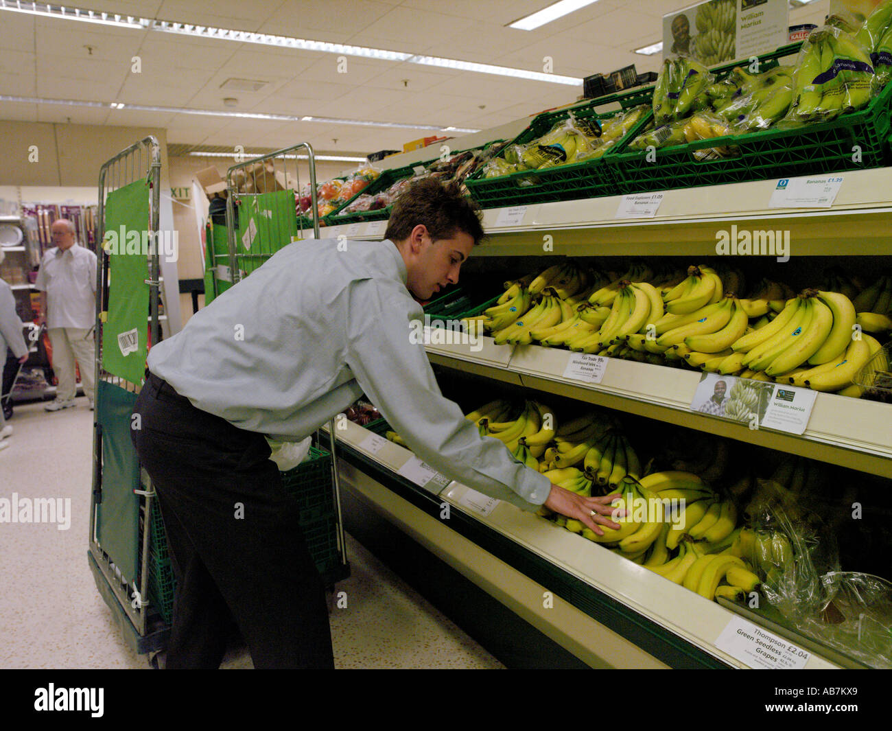 Stacking Fairtrade Bananas from Trolley in Waitrose Supermarket Epsom ...