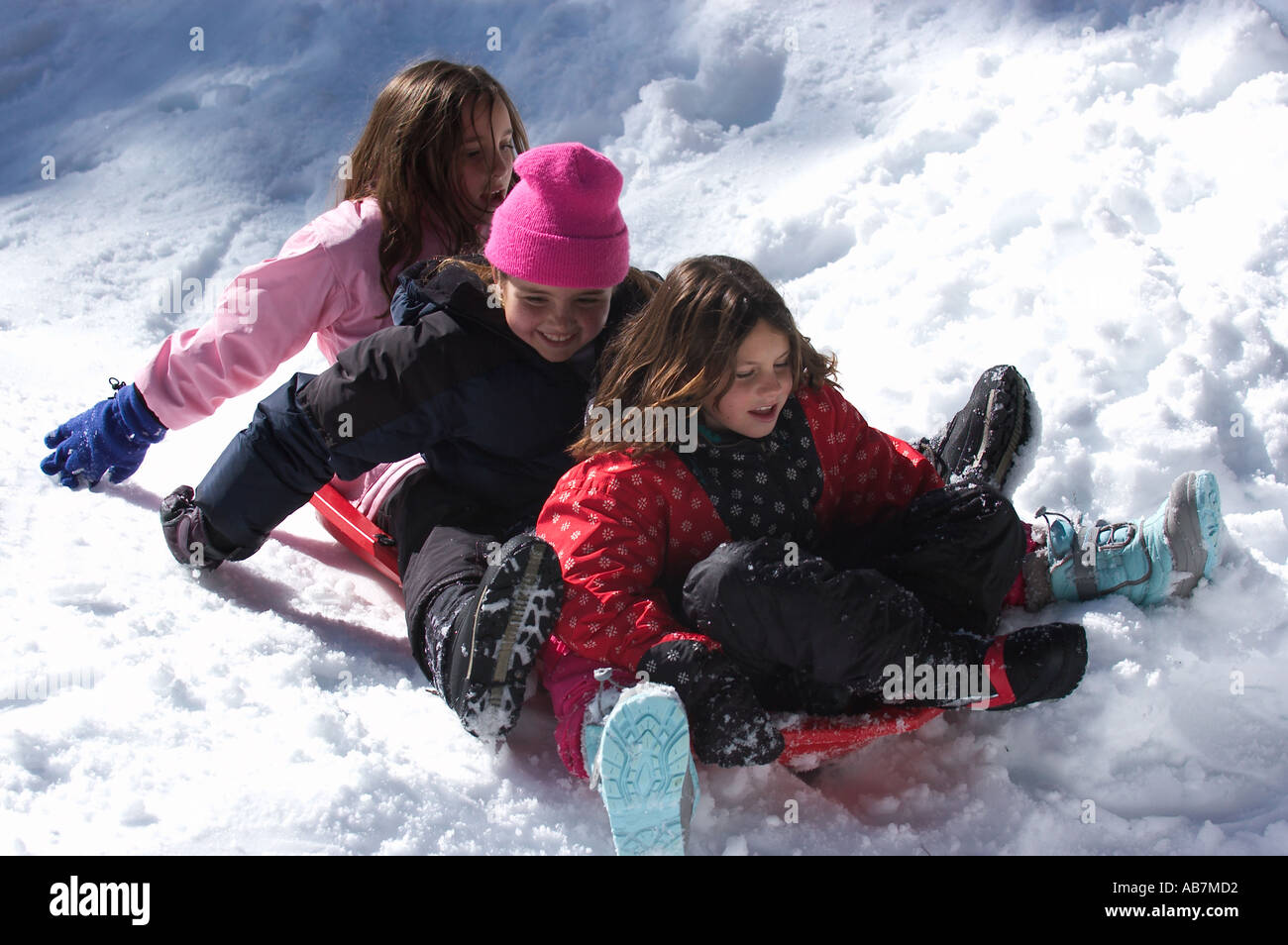 three snow girls on sled Stock Photo - Alamy