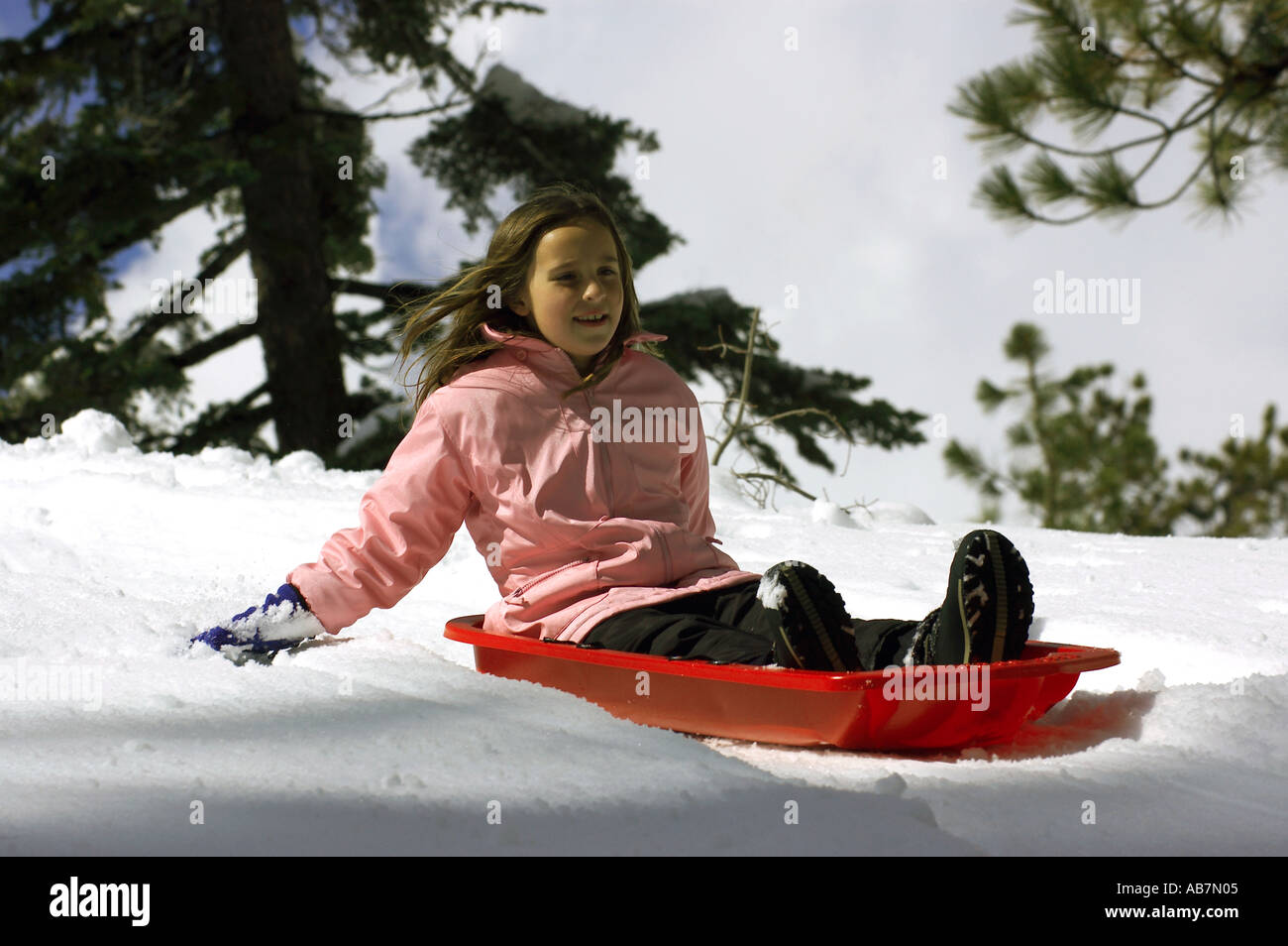 girl on snow sled Stock Photo - Alamy