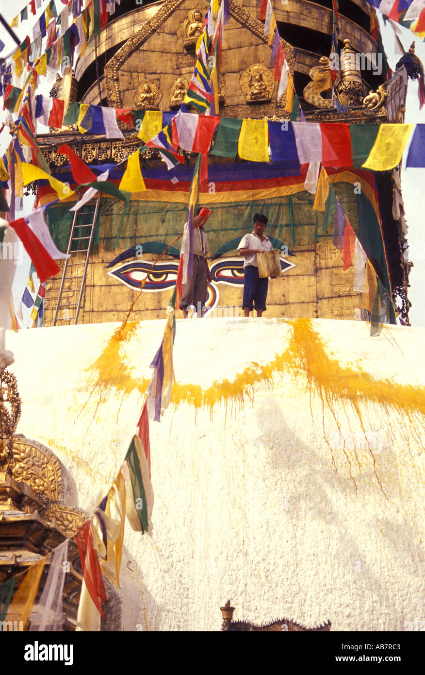Nepal - Kathmandu - A devotee paints the symbol of the lotus flower ...