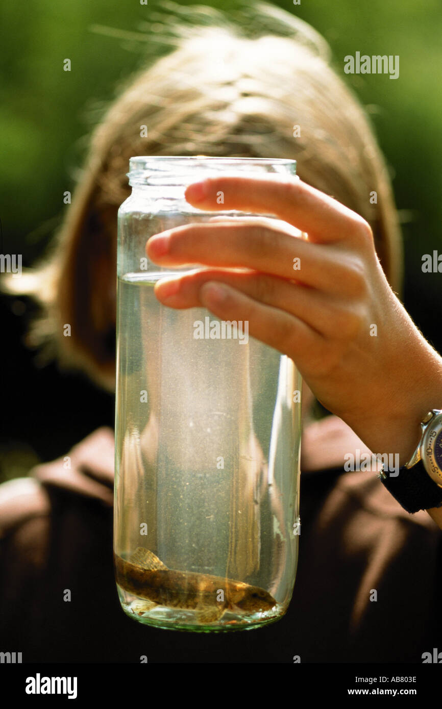 Child holding fish in a jar Stock Photo - Alamy