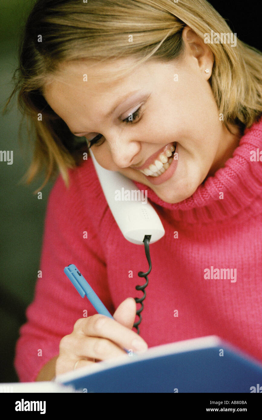Girl on using a telephone Stock Photo - Alamy