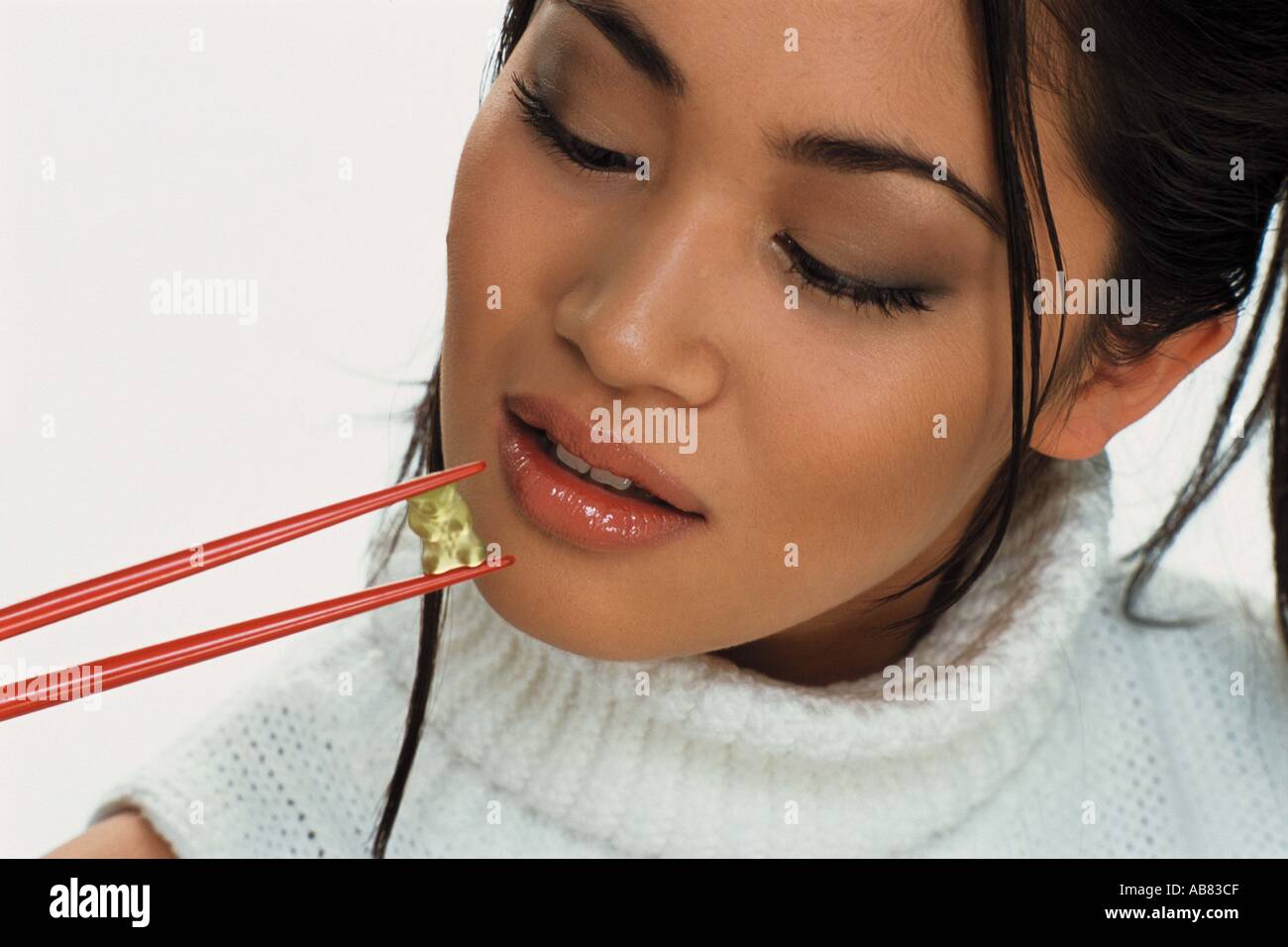 Young woman eating sweets Stock Photo - Alamy