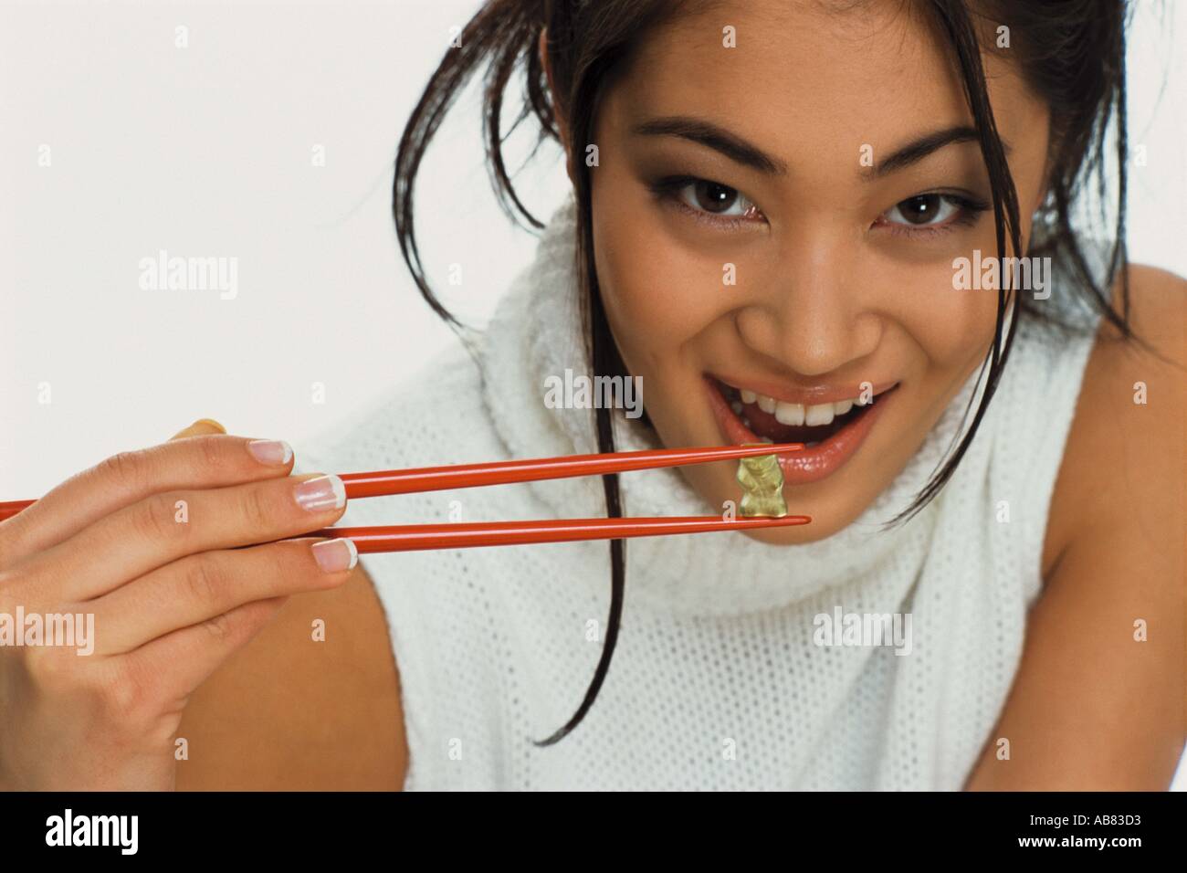 Young woman eating sweets Stock Photo - Alamy