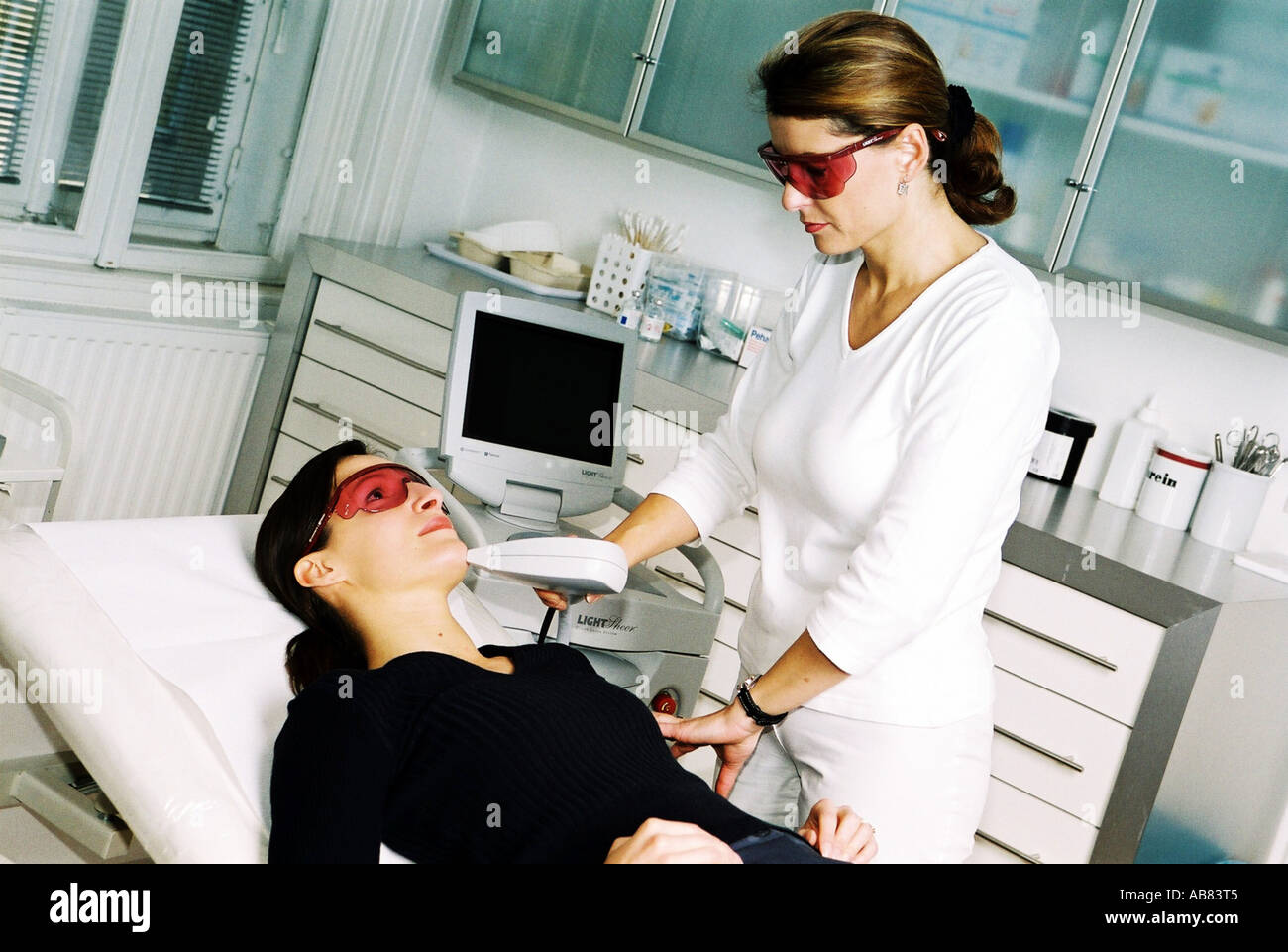 dermatologist carrying out laser surgery in clinical practice Stock ...