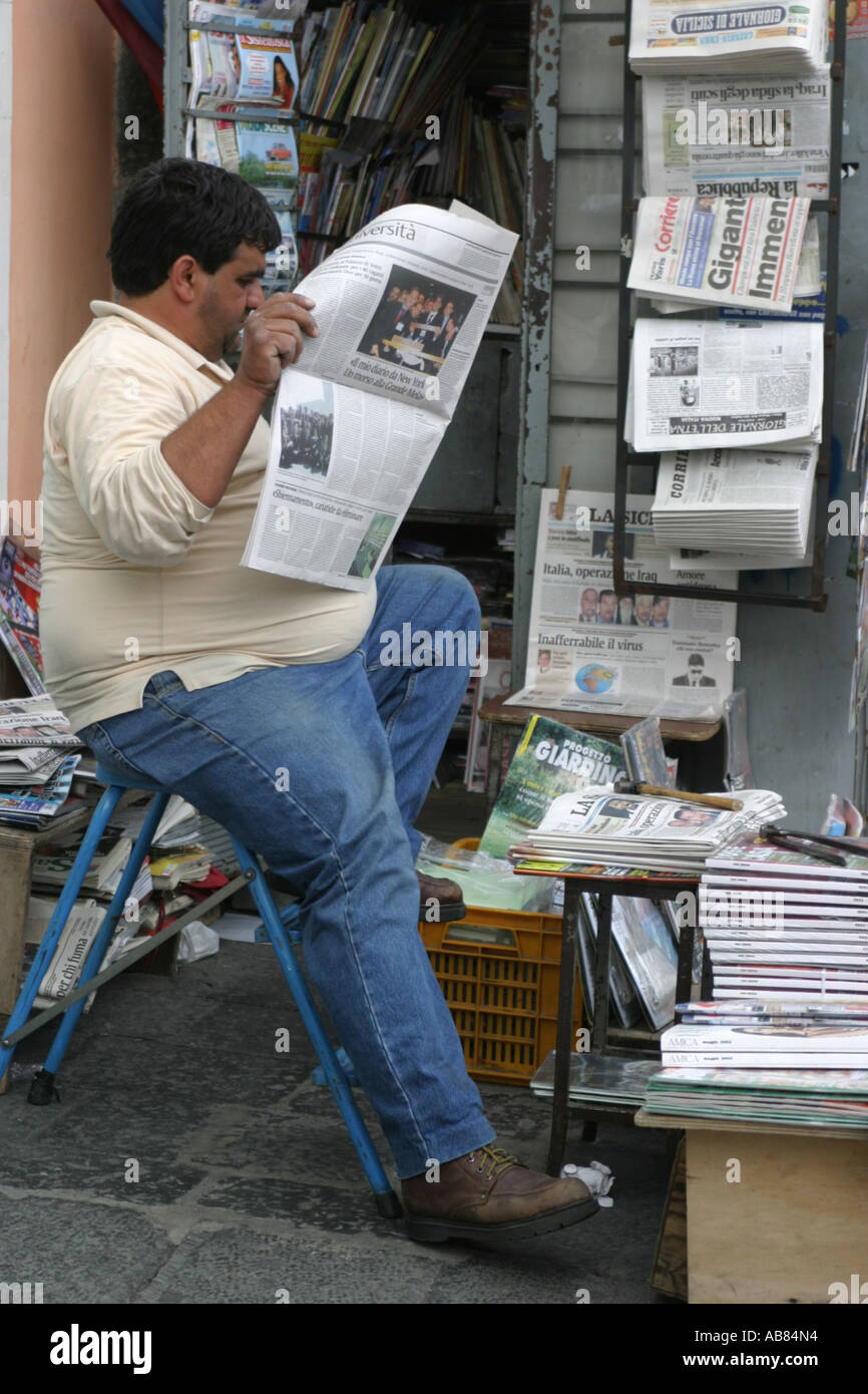 Fat man reading newspaper hi-res stock photography and images - Alamy