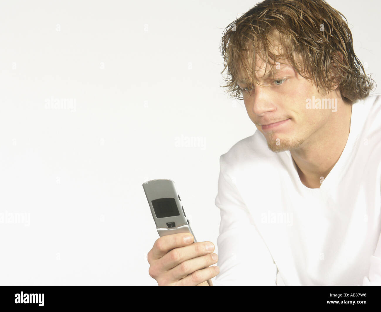halfportrait of a young man with mobile in hand, Germany Stock Photo ...