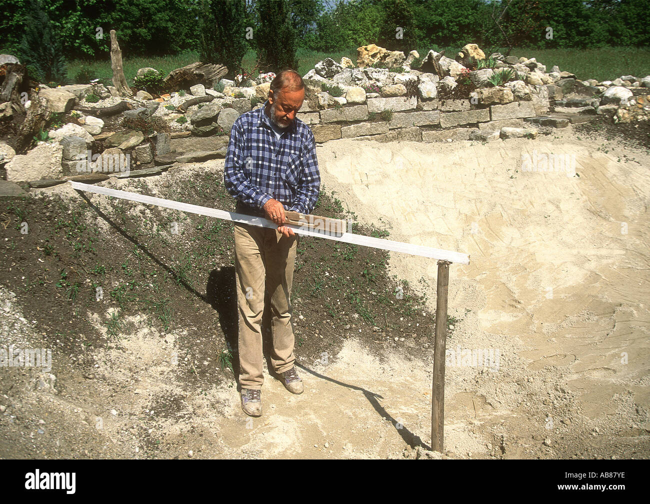 man building a garden pond, Germany Stock Photo - Alamy