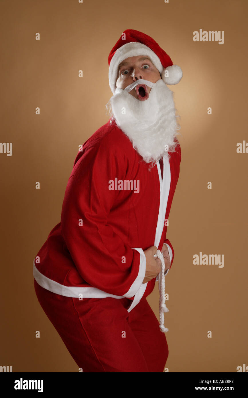 portrait of a costumed Santa Claus, holding his belly, laughing Stock ...
