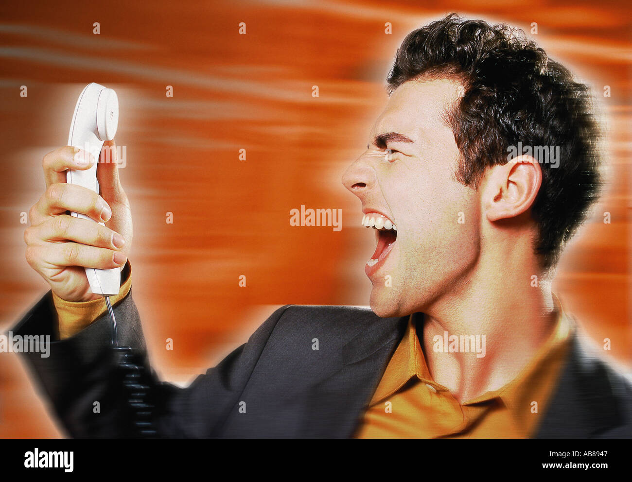 Man shouting into phone Stock Photo - Alamy