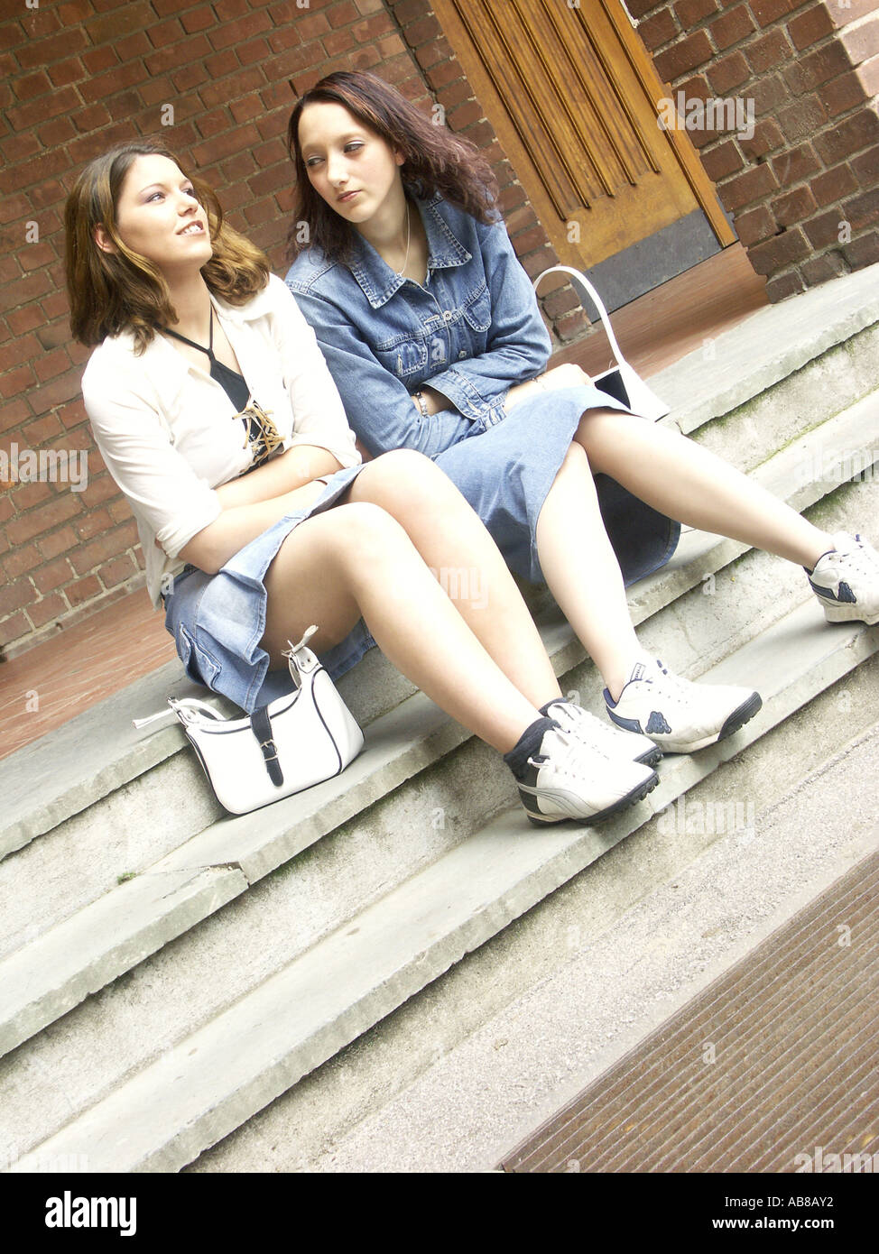 two girls sitting on stairs Stock Photo - Alamy