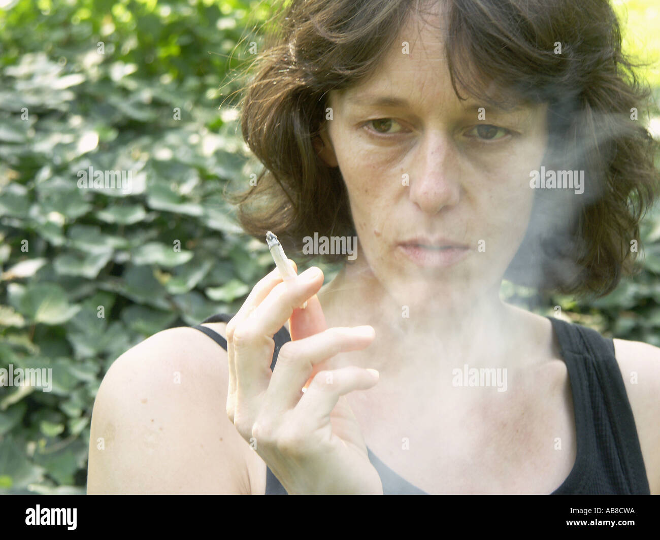 portrait of a smoking woman Stock Photo - Alamy