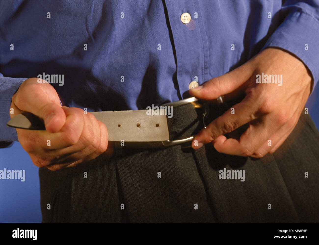 Tightening the belt Stock Photo - Alamy