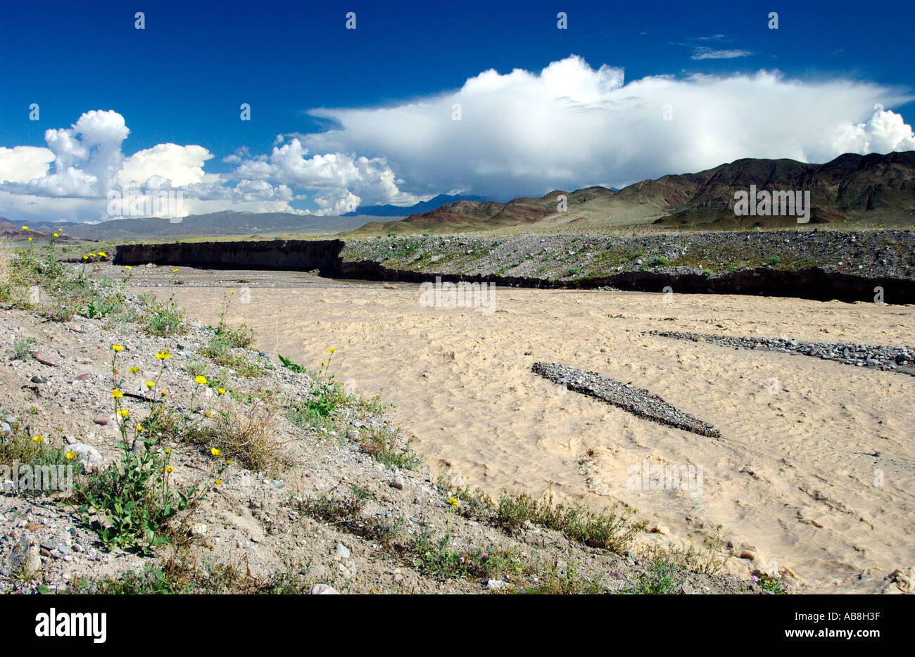 Desert rain shower clouds flash flood water runoff and erosion in ...