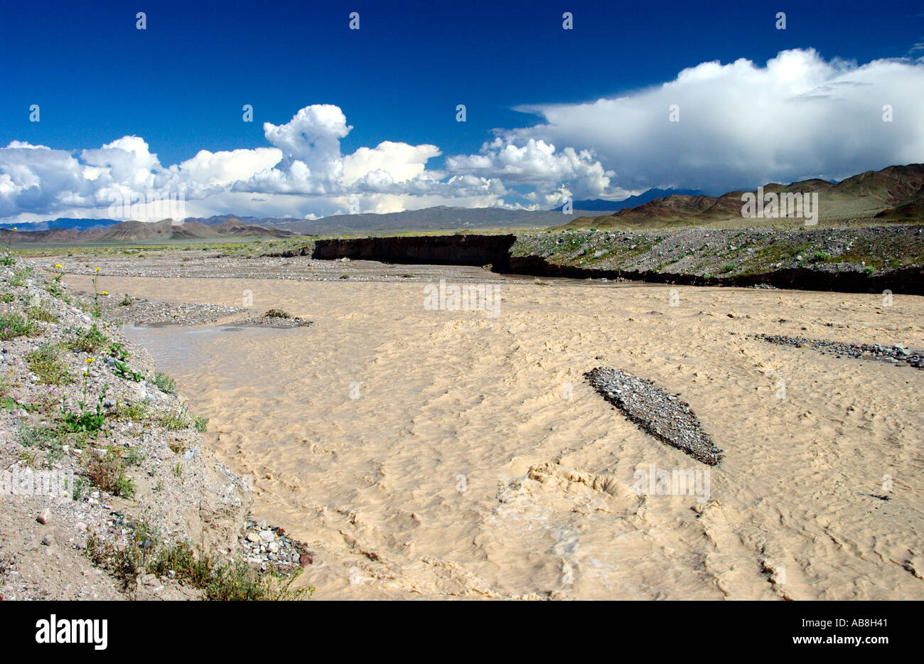 Desert rain shower clouds flash flood water runoff and erosion in ...