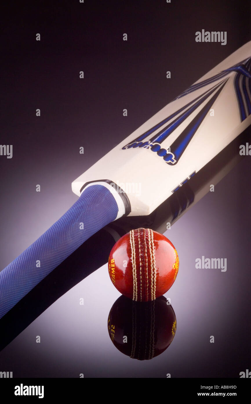 Close-up of a traditional red leather cricket ball alongside the blue ...