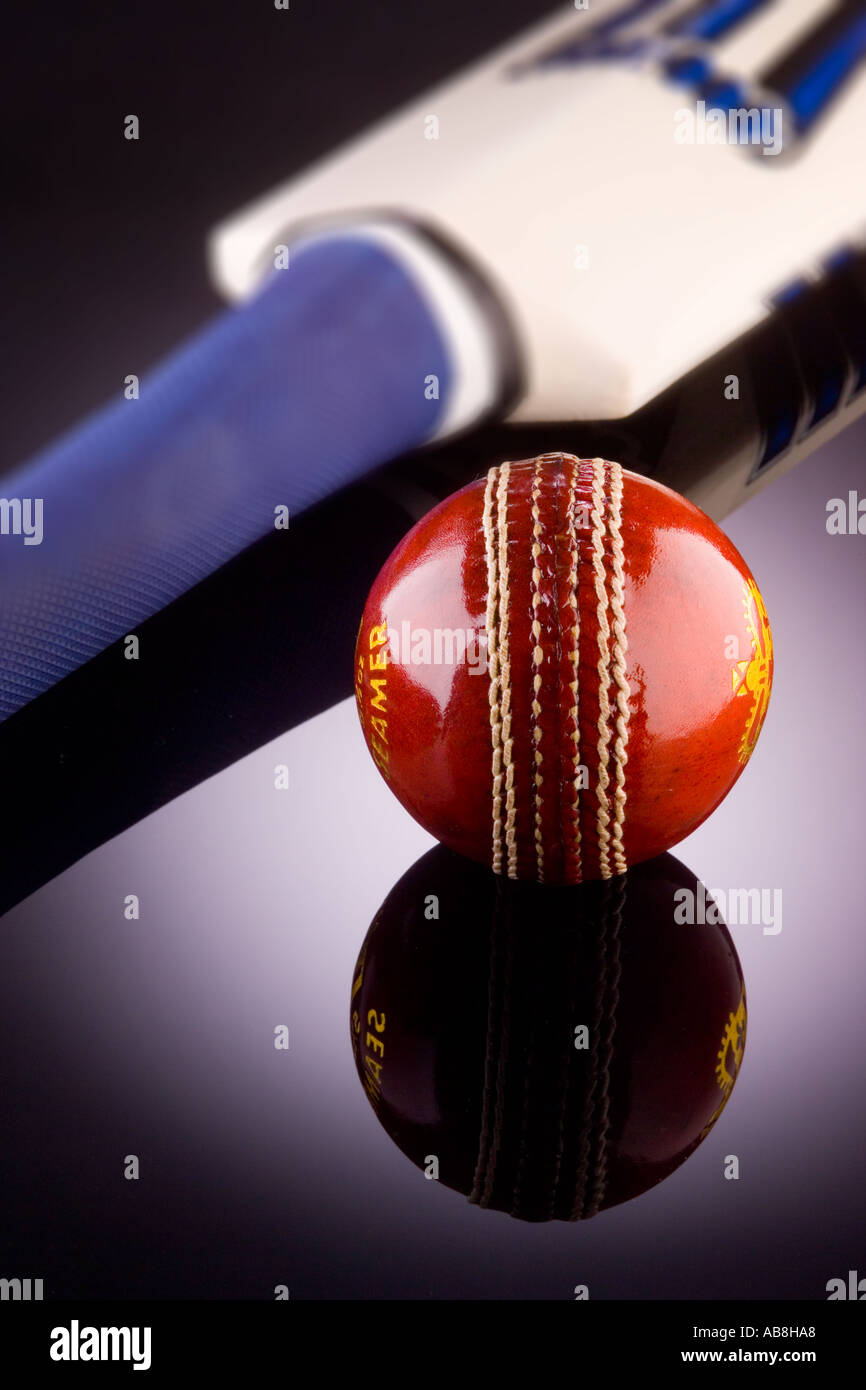 Close-up of a traditional red leather cricket ball alongside the blue ...