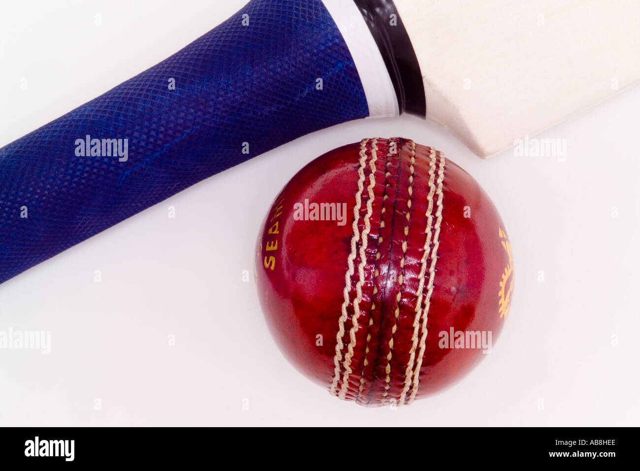Close-up of the blue rubber hand grip on a cricket bat, alongside a ...
