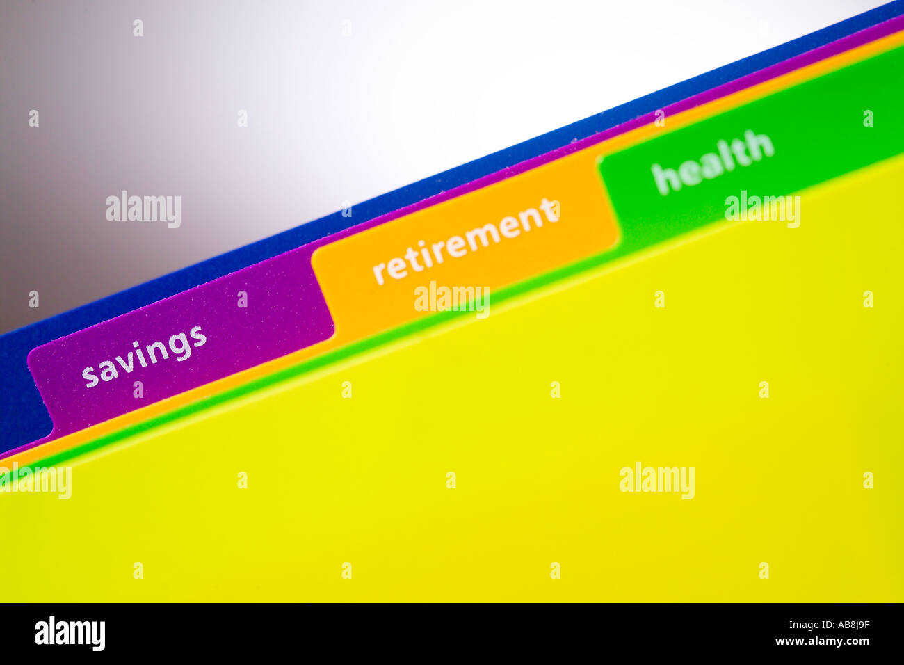 Brightly coloured plastic subject divider tabs labelled ‘savings ...