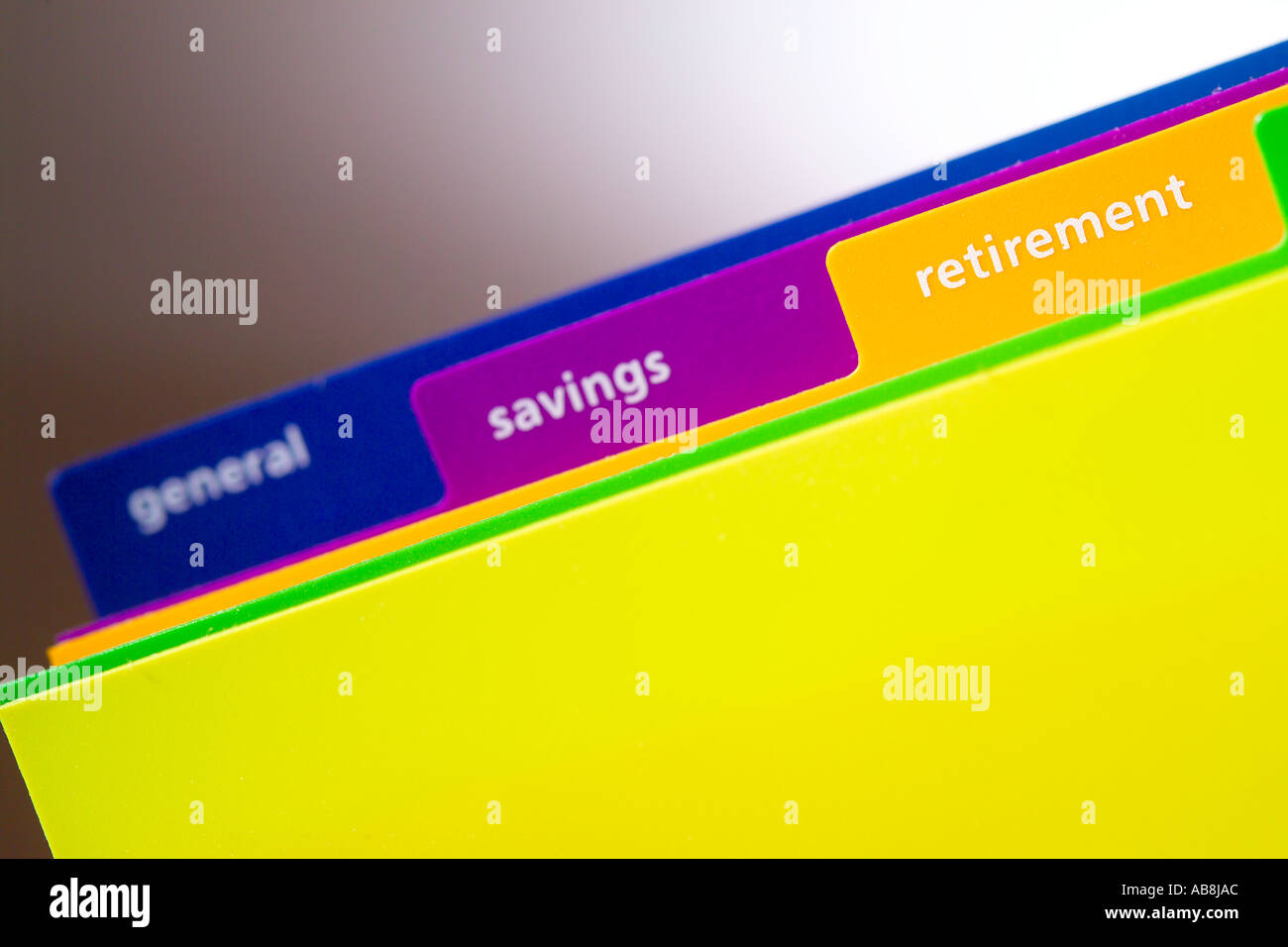 Brightly coloured plastic subject divider tabs labelled ‘savings ...