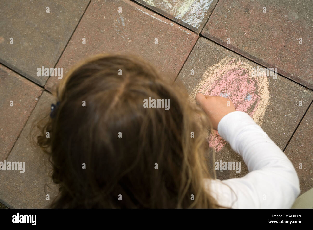 little girl writing on the tiles Stock Photo - Alamy