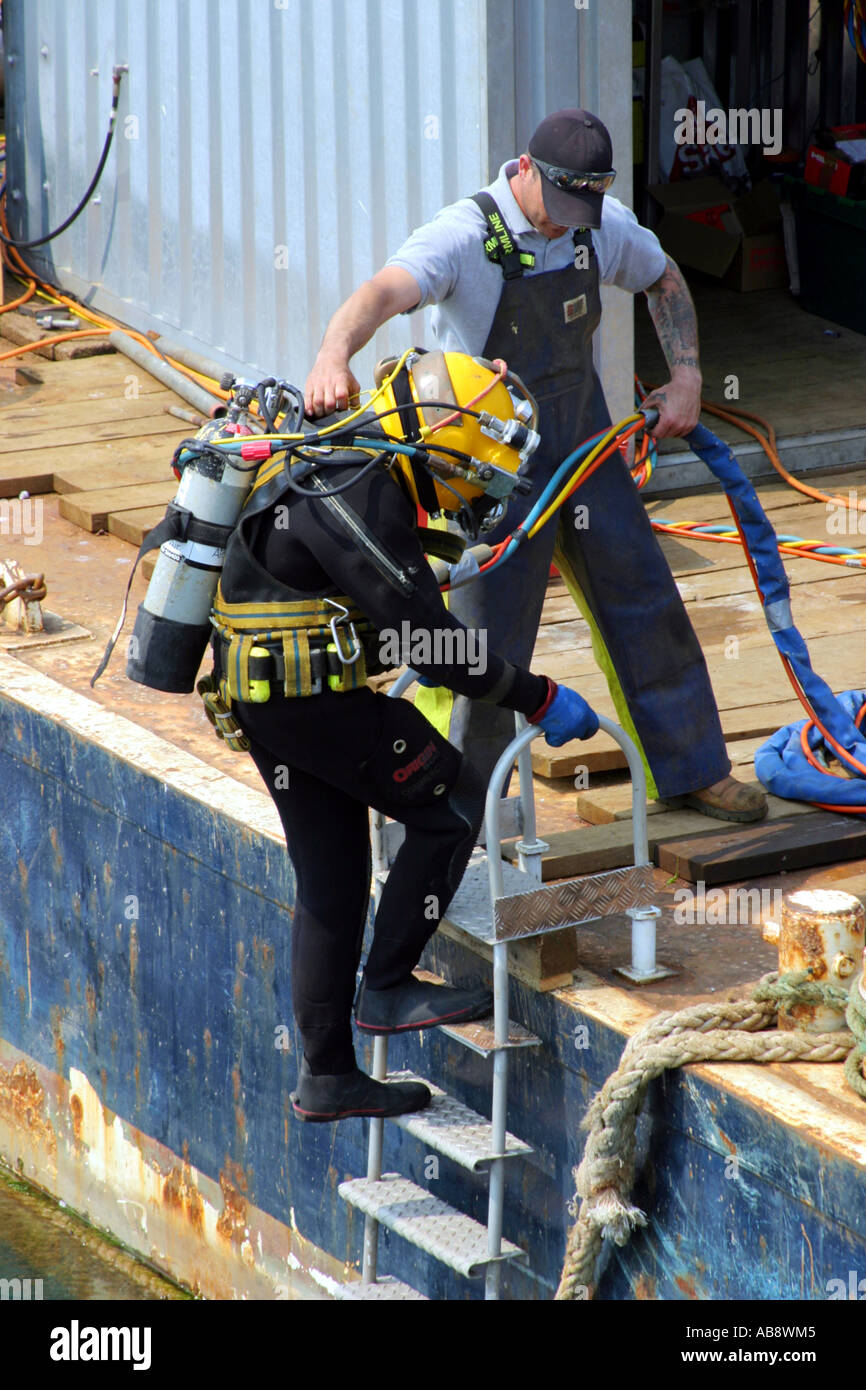 Diver entering the water in Torquay harbour to perform maintenance on ...