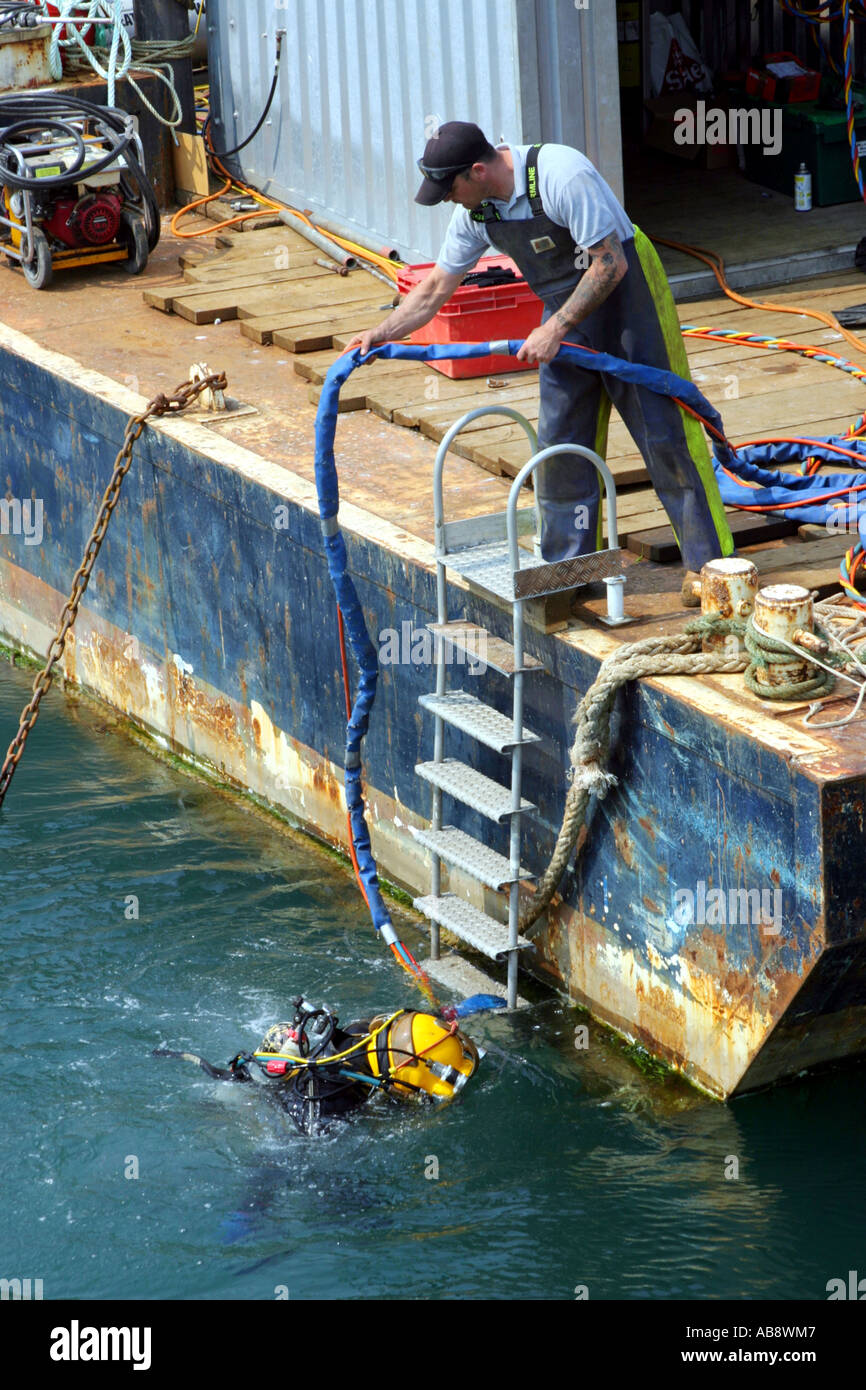 Diver entering the water in Torquay harbour to perform maintenance on ...
