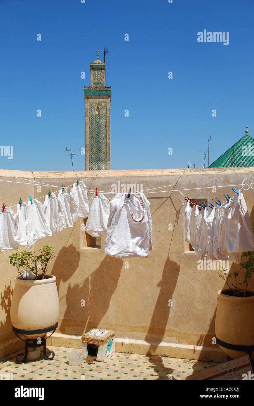 Laundry in the wind and minarett of the Kairaouine mosque Fez Morocco ...