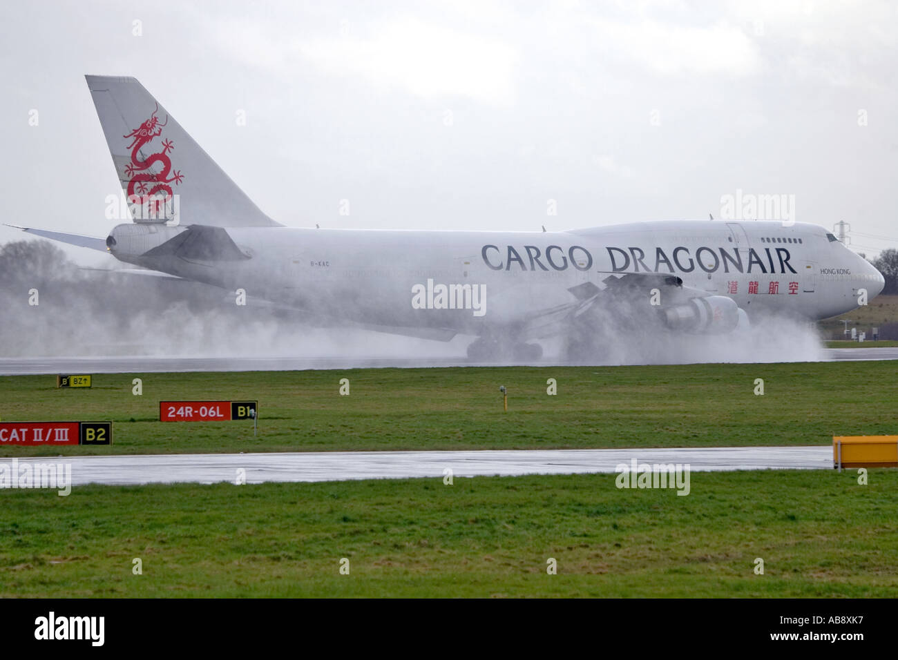 Jumbo jet landing in rain with spay Stock Photo - Alamy