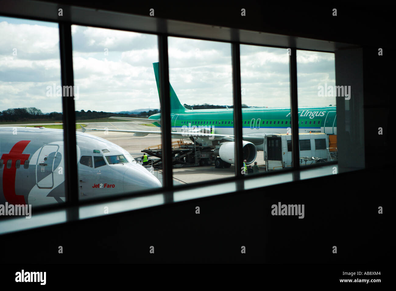 View of aeroplanes from through terminal window Stock Photo - Alamy