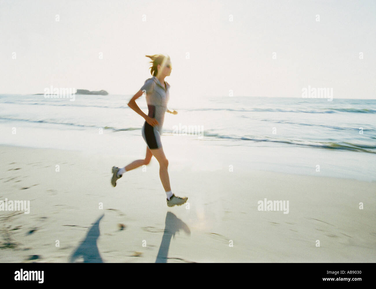 Fitness woman running sea hi-res stock photography and images - Alamy