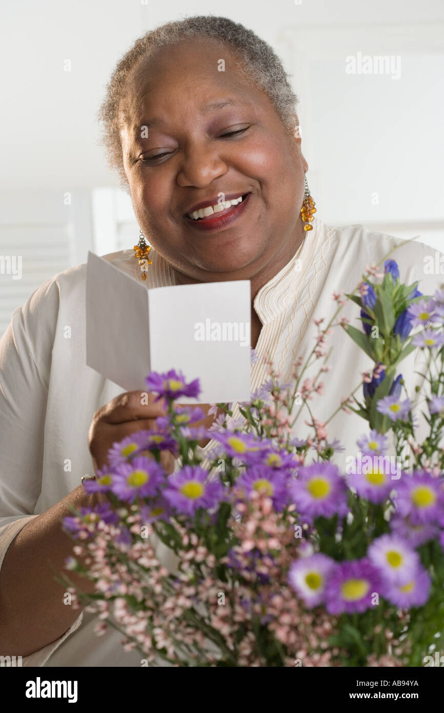 Senior woman reading a card Stock Photo - Alamy