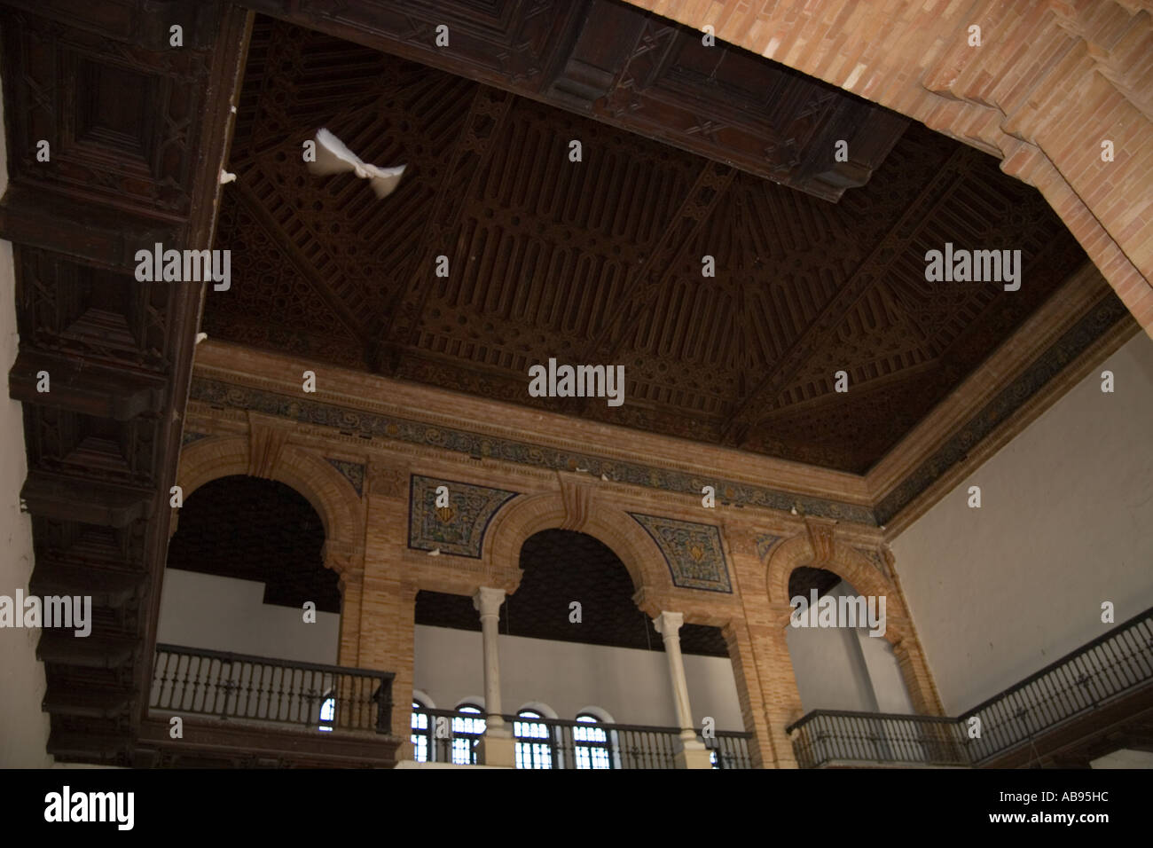 A dove takes flight in to the rafters in Seville Stock Photo - Alamy