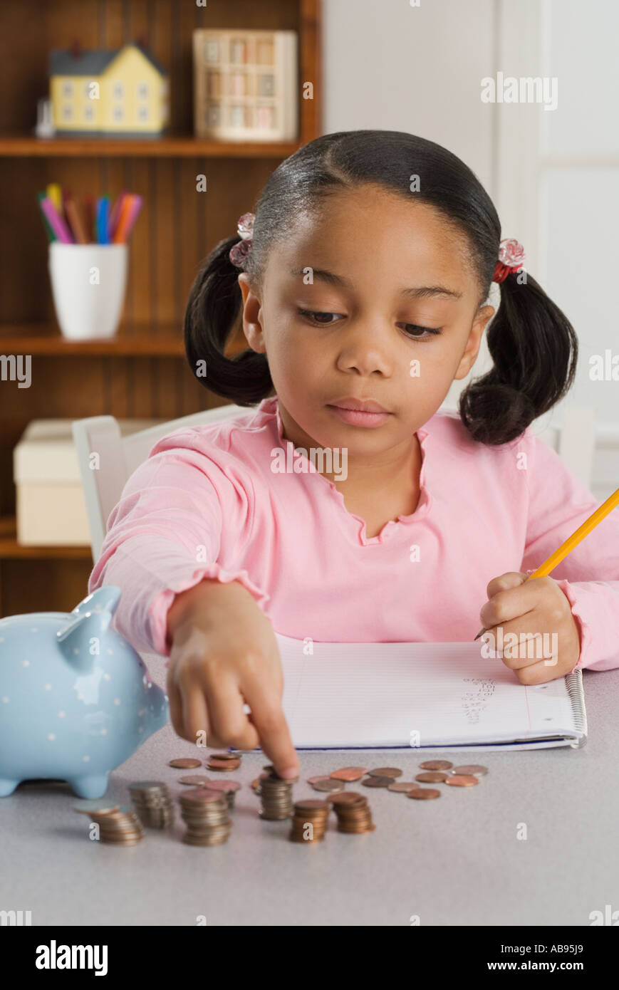 Young girl counting coins Stock Photo - Alamy