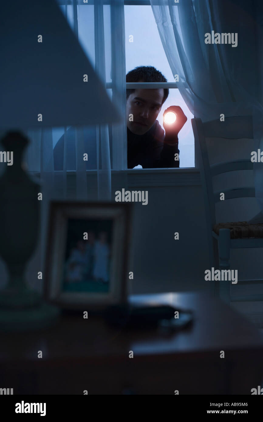 Thief peering in a window Stock Photo - Alamy