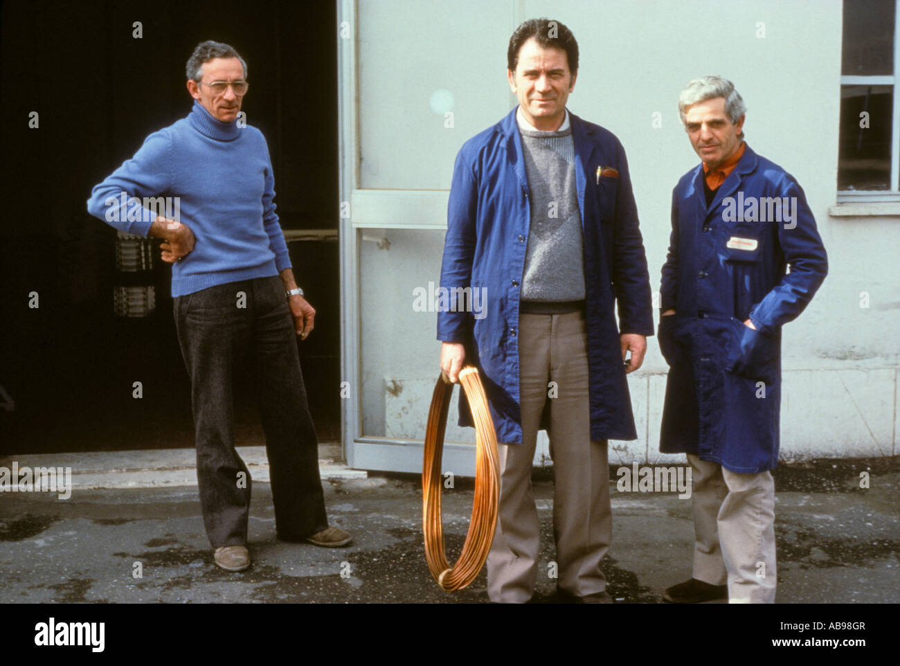 three factory industrial workers Rome Italy Italian coil coiled brass ...