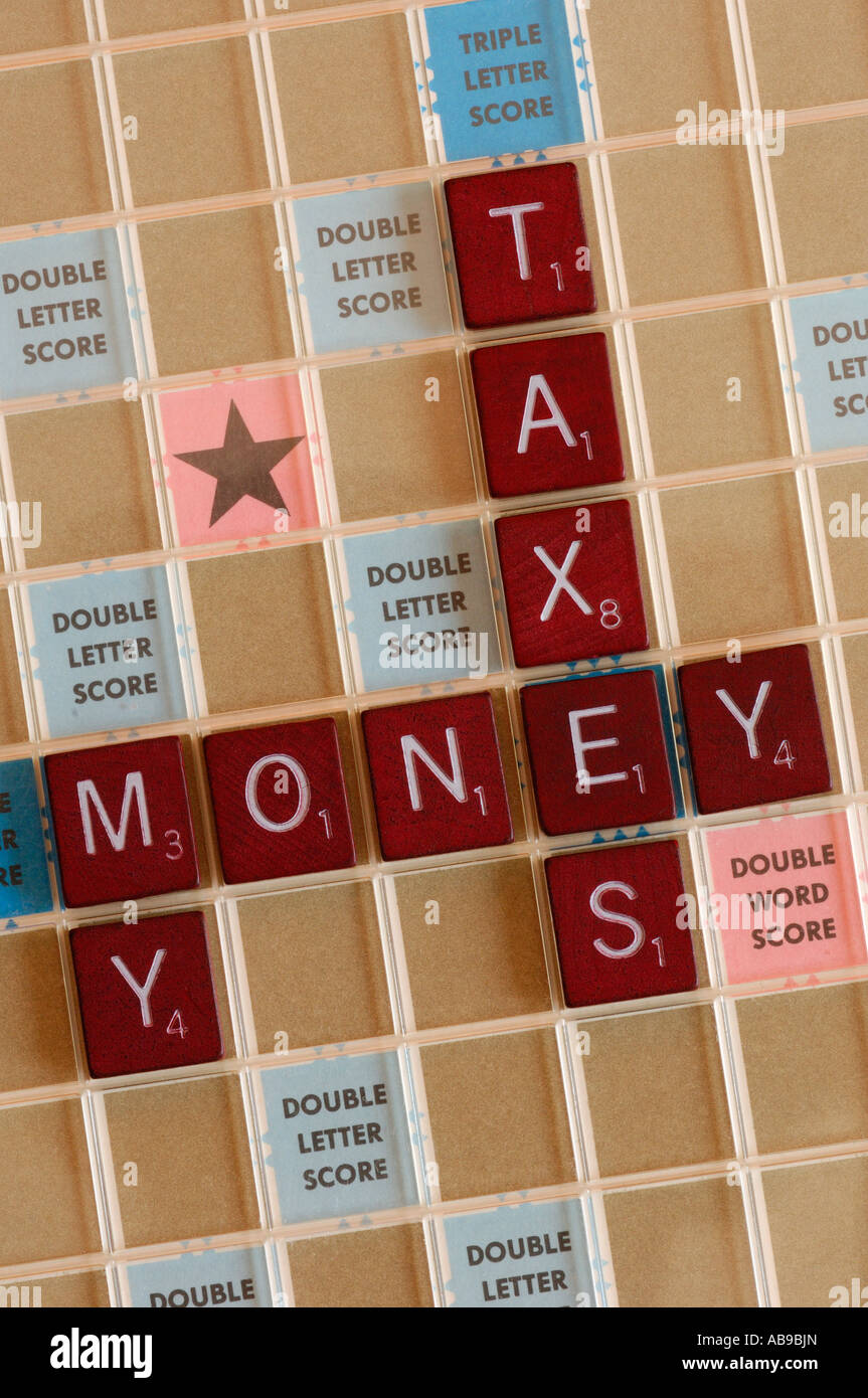 My money and taxes spelled out with Scrabble tiles Stock Photo - Alamy