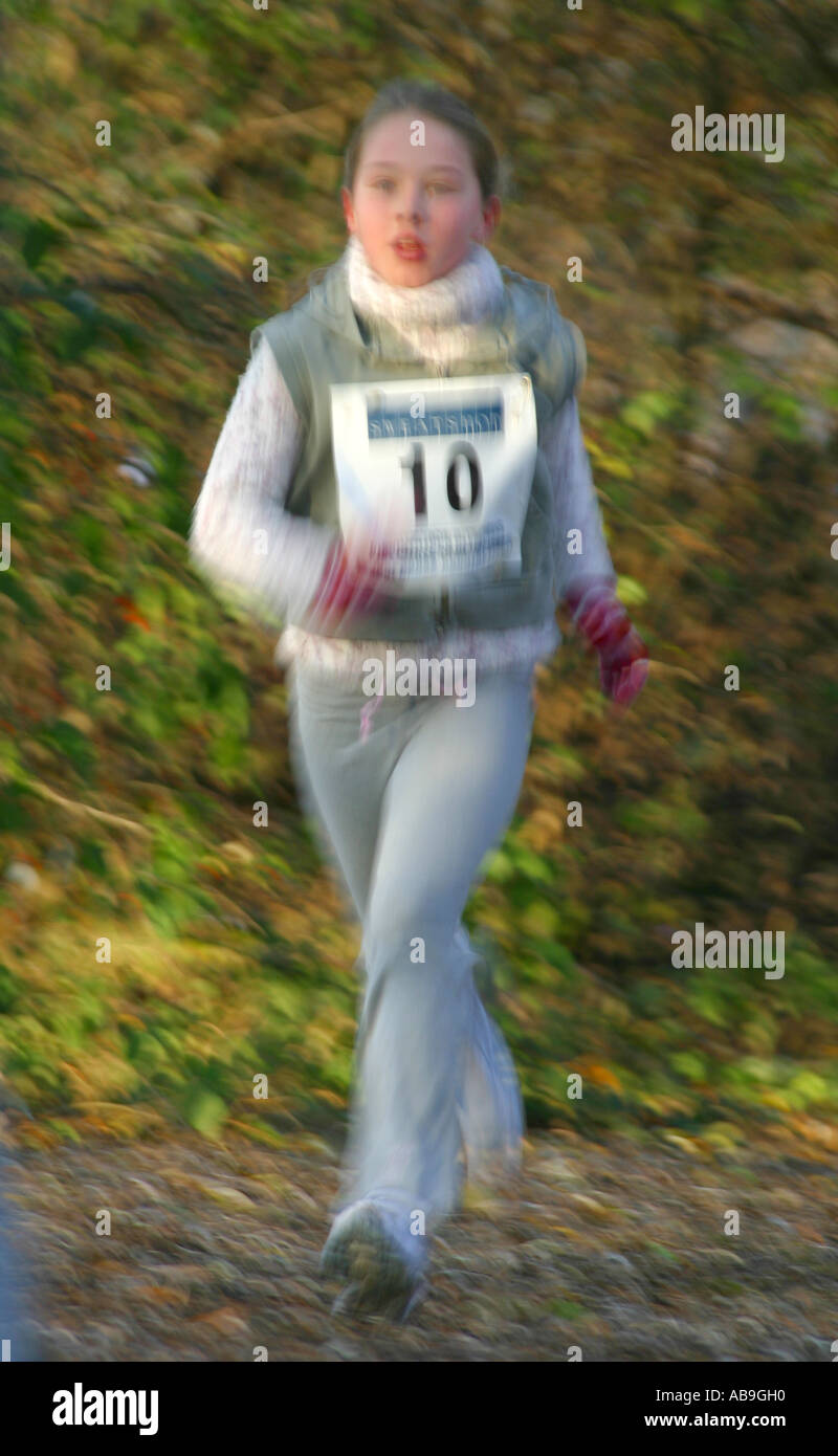 Young girl running in school cross country race Stock Photo - Alamy