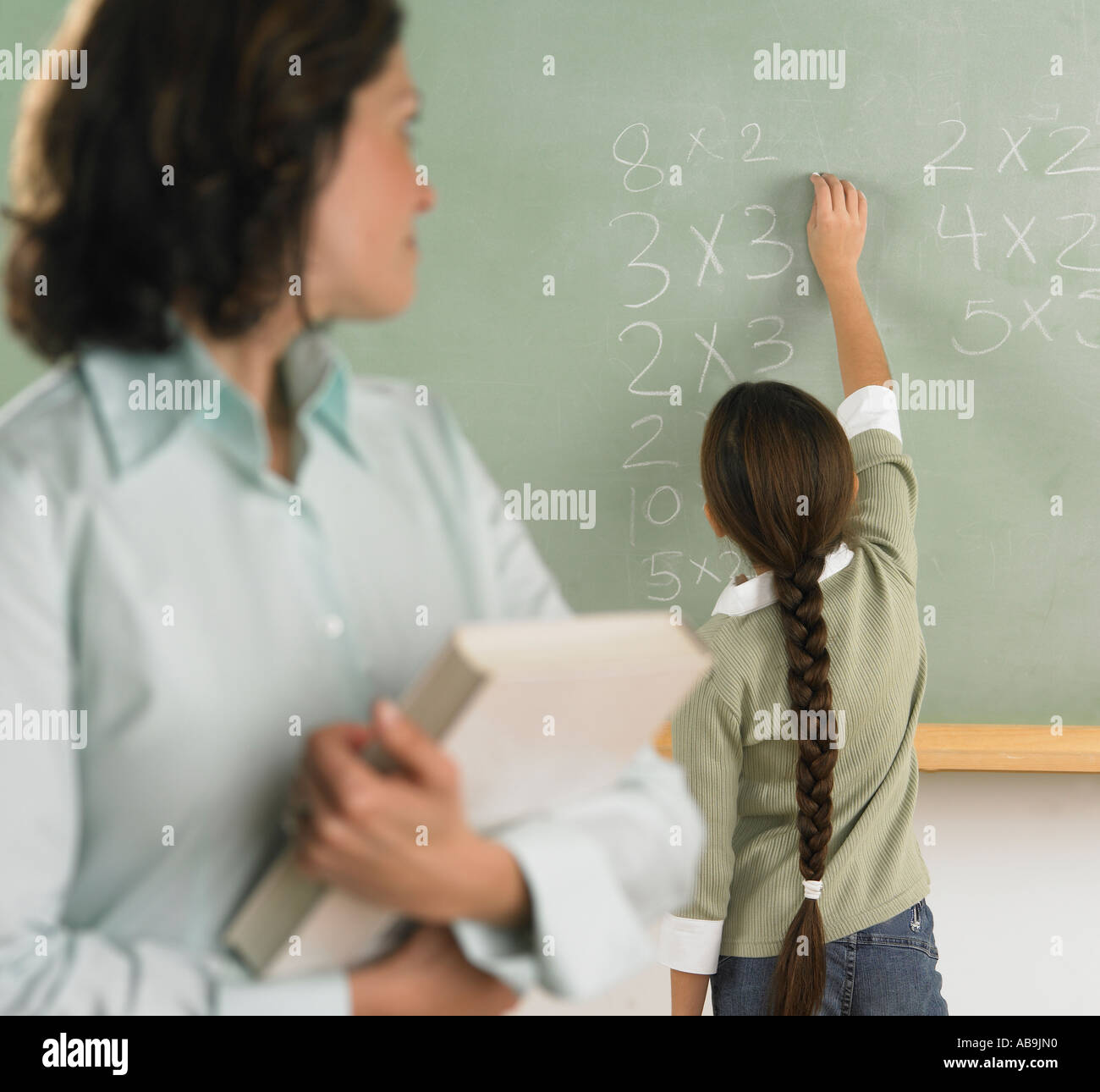 Student solving arithmetic on the chalkboard Stock Photo - Alamy
