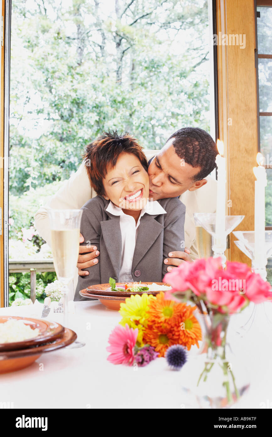Couple kissing at the dinner table Stock Photo - Alamy