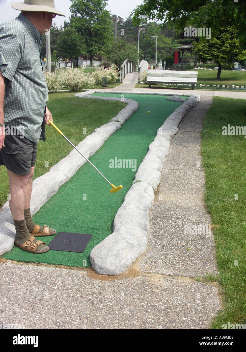 Man Playing Miniature Golf Stock Photo - Alamy